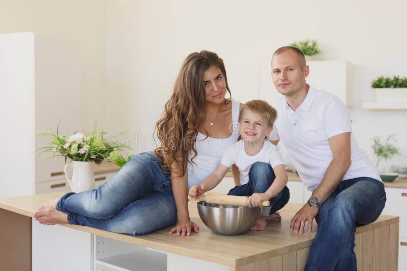 Happy Family Looking at the Camera in Kitchen Stock Photo - Image of ...