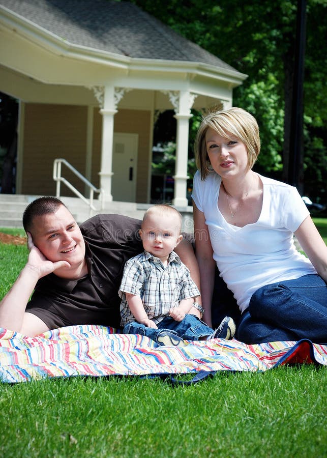 Happy Family Lying in Grass - Vertical Stock Image - Image of seated ...