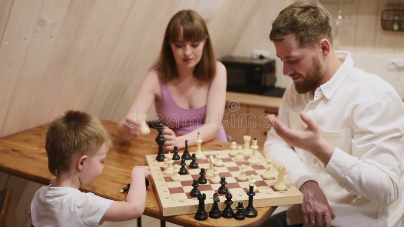 Happy Family Mother, Dad and Their Son Playing Chess in the Room Stock ... Happy Family Mother, Dad and Their Son Playing Chess in the Room Stock ...