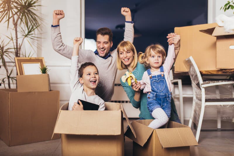Family Moving Home with Boxes Around Stock Image - Image of happy, love ...