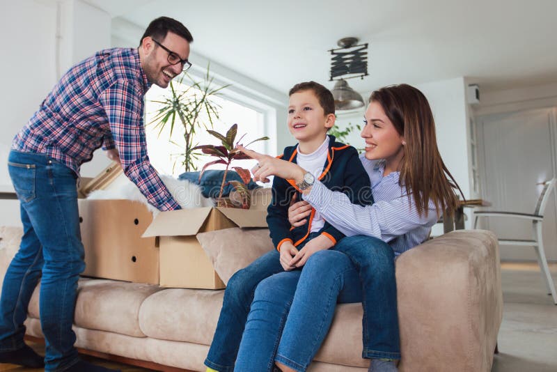 Family Moving Home with Boxes Around, and Having Fun Stock Image ...