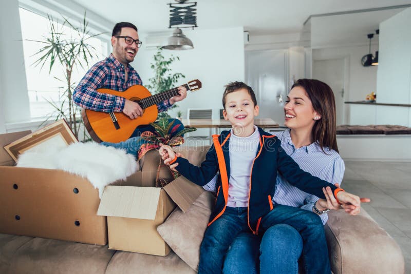 Family Moving Home with Boxes Around, and Having Fun Stock Image ...