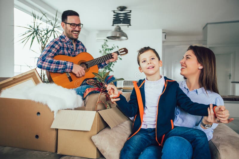 Family Moving Home with Boxes Around, and Having Fun Stock Image ...