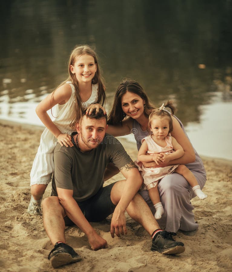 Happy Family is Next To the Lake Stock Photo - Image of four, cheerful ...