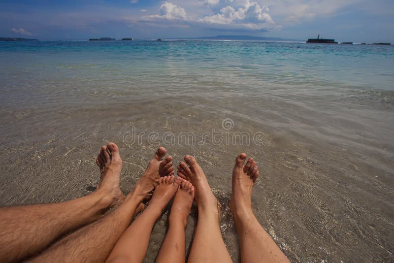 Happy family by the ocean stock photo. Image of seashore - 175453904