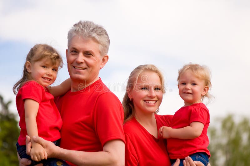 Happy Family Outdoor In Red Stock Image - Image of shirt, girls: 14569333