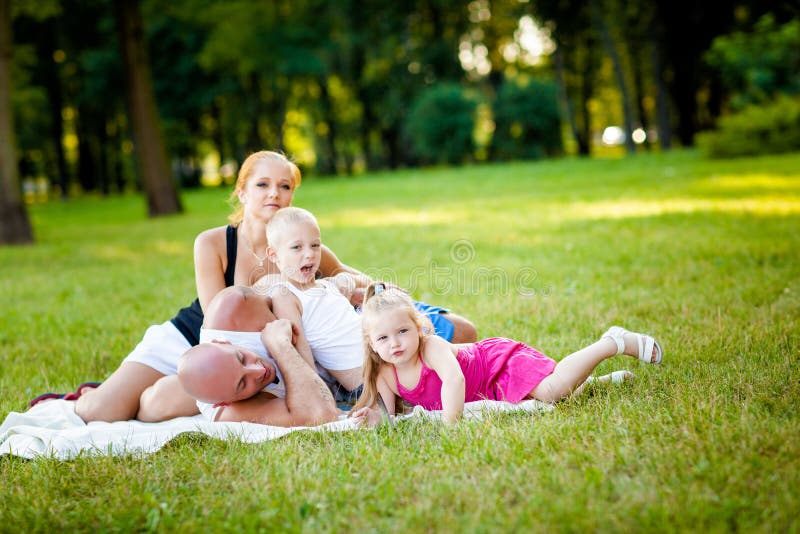Happy family in a park stock image. Image of park, summer - 26365013