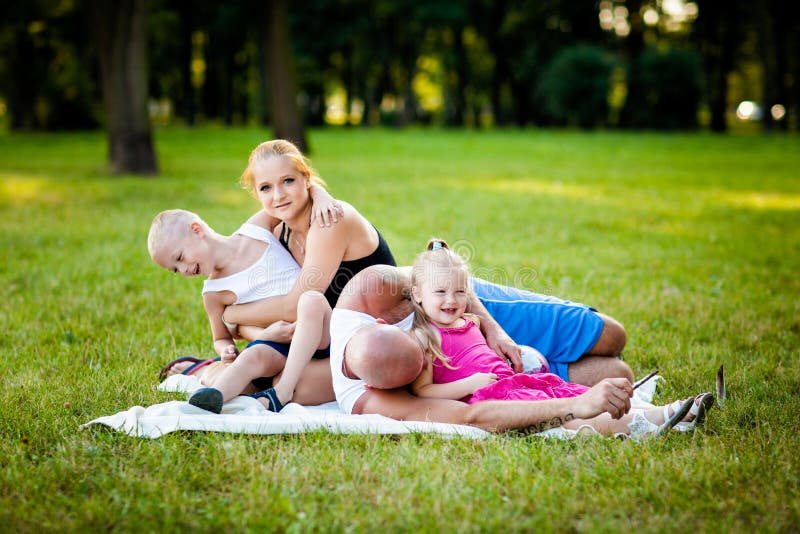 Happy family in a park stock image. Image of park, multicolor - 26365285