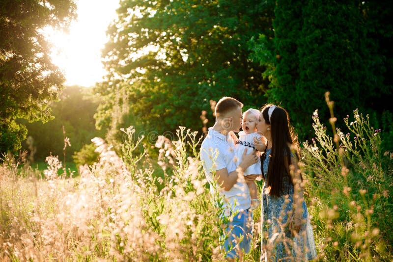 Happy Family in the Park Evening Light. the Lights of a Sun. Stock ...