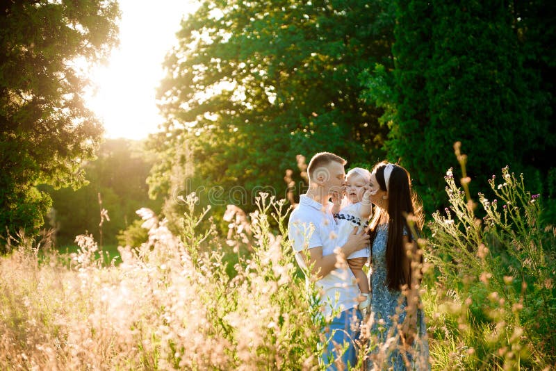 Happy Family in the Park Evening Light. the Lights of a Sun. Stock ...