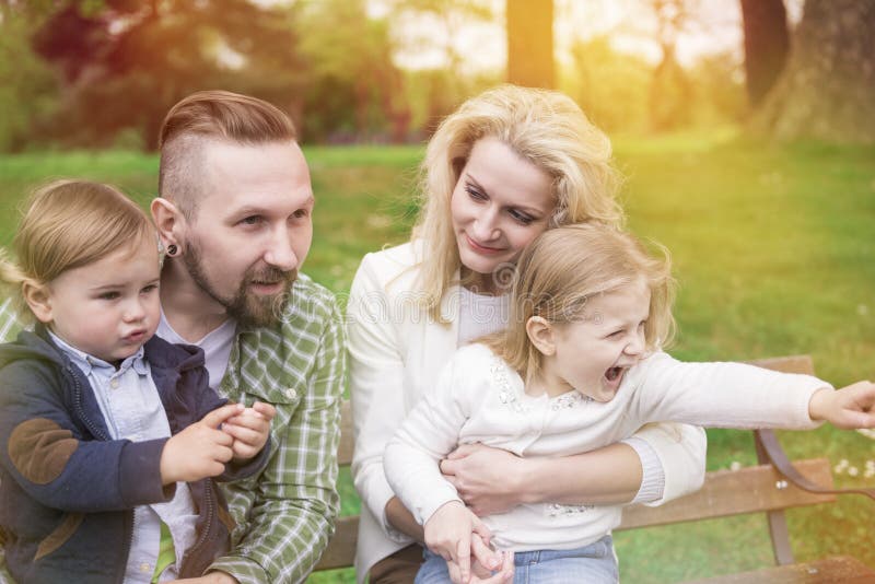 Happy family in park stock photo. Image of father, bonding - 59074792