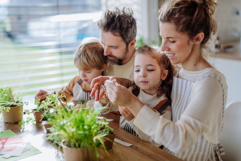 Happy Family Planting Herbs Together at Spring. Stock Photo - Image of ...