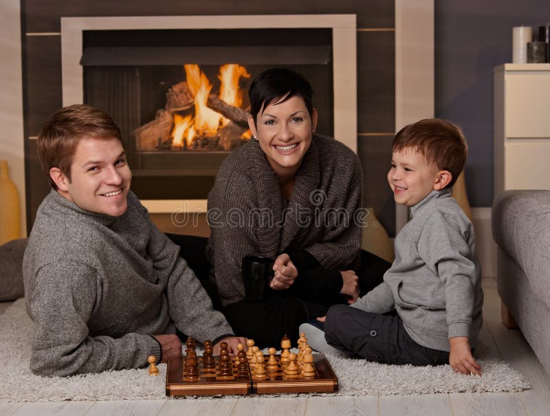 Happy family playing chess stock photo. Image of expression - 27468680