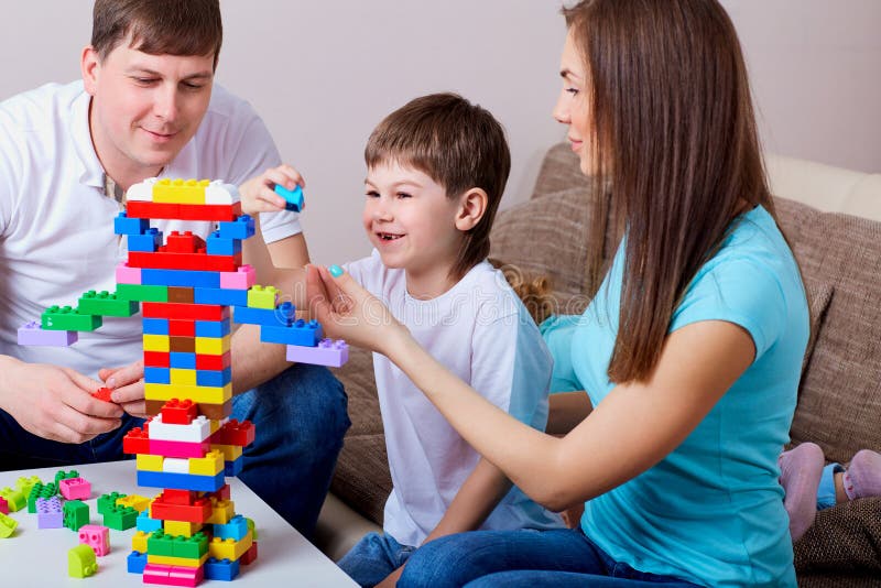 Happy Family Playing with Colorful Blocks Inside at Home. Stock Photo ...