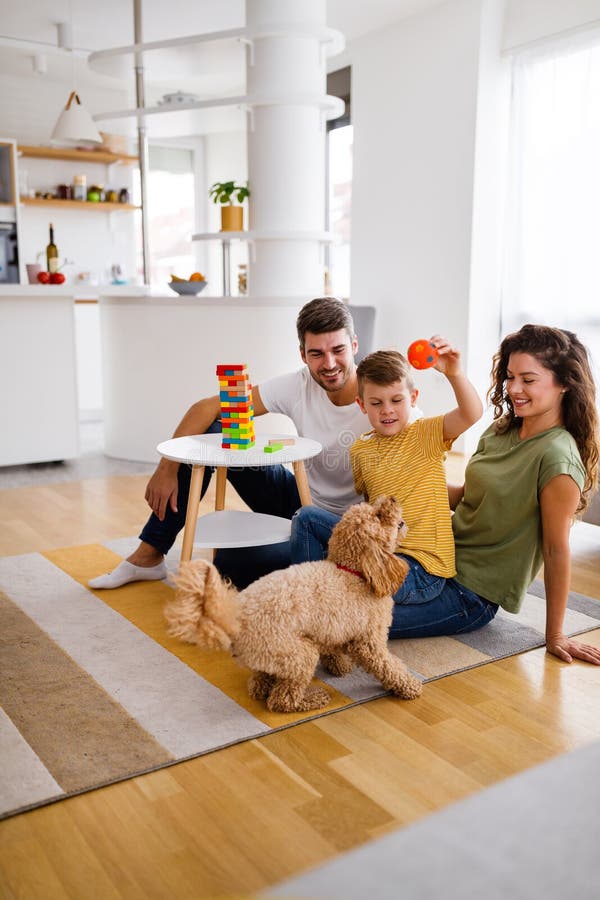 Happy Family Playing, Having Fun with Dog at Home Stock Photo - Image ...