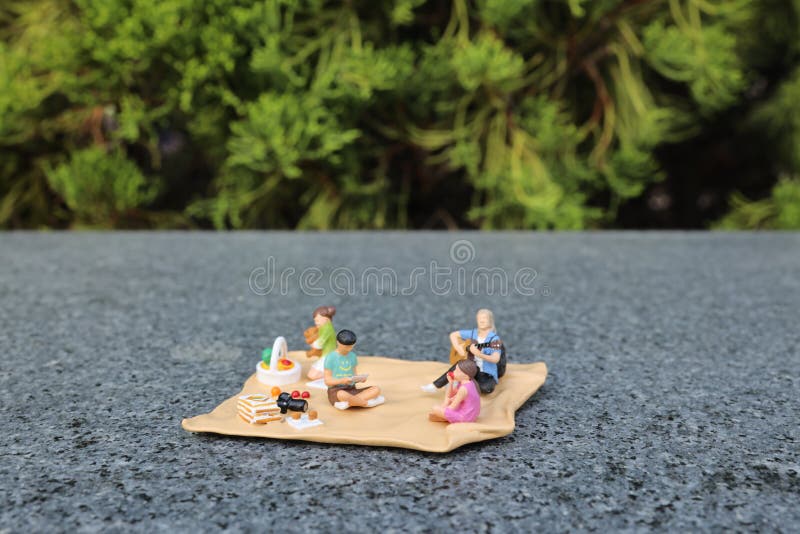 Miniature Figure Happy Family Playing Together in a Picnic Outdoors ...