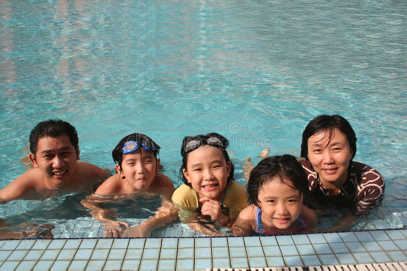 Happy family in the pool stock image. Image of excitement - 12629737