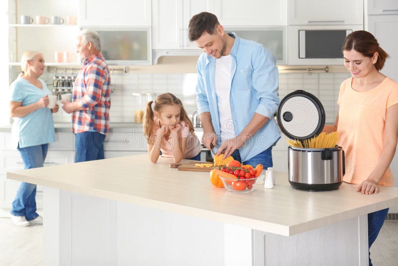 Happy Family Preparing Food with Modern Multi Cooker Stock Photo ...
