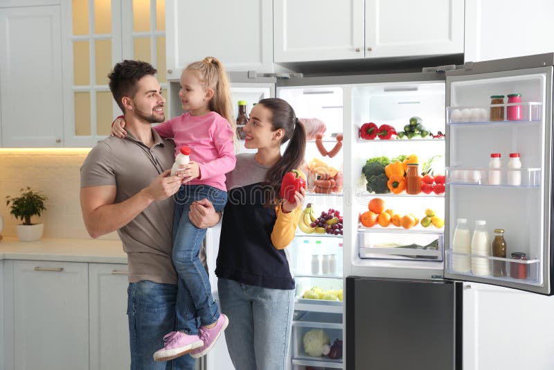 Family with Products Near Open Refrigerator in Kitchen Stock Image ...