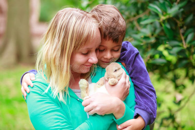 Happy Family with a Rabbit in Their Hands in the Park Stock Photo ...