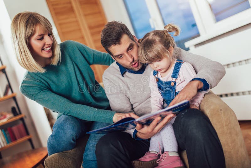Family Reading Book at Home Stock Photo - Image of bonding, leisure ...