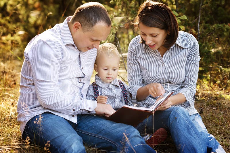 Happy family reading book stock image. Image of child - 35125035