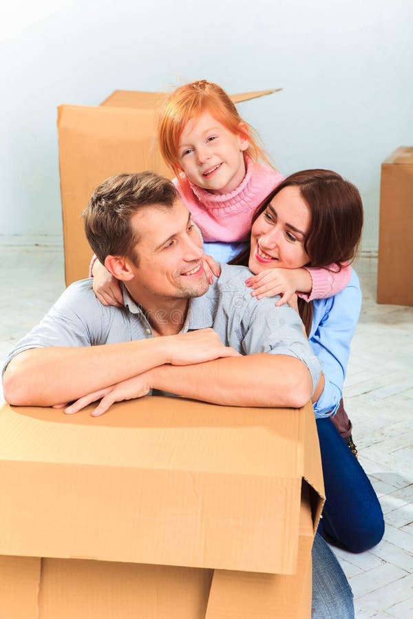 Young Family on Moving Day Looking Happy Stock Image - Image of ...