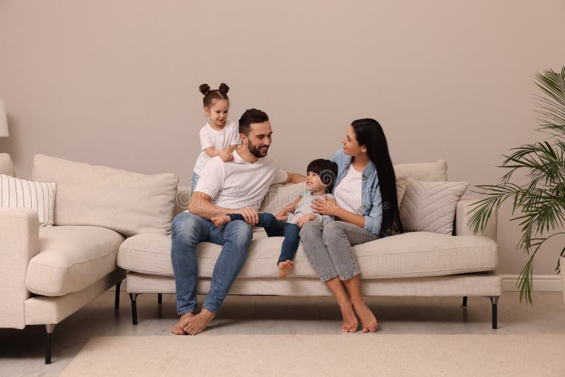 Happy Family Resting on Sofa in Living Room Stock Photo - Image of ...