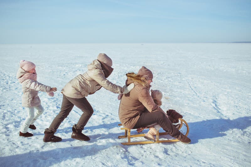 Happy Family Ride on a Sledge in Winter Sunny Day Stock Photo - Image ...