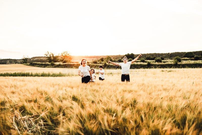 Happy Family Running through the Countryside. Family Having Fun Field ...