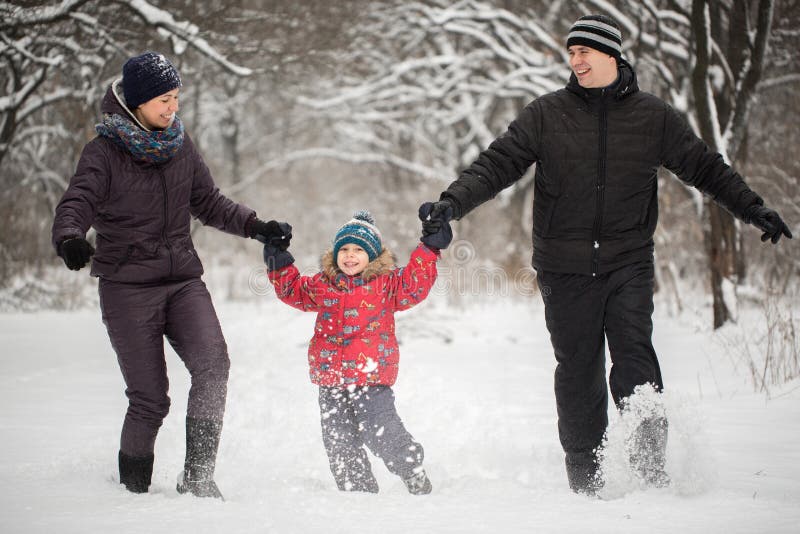 Happy Family Running on Snow in Winter. Stock Photo - Image of outdoor ...