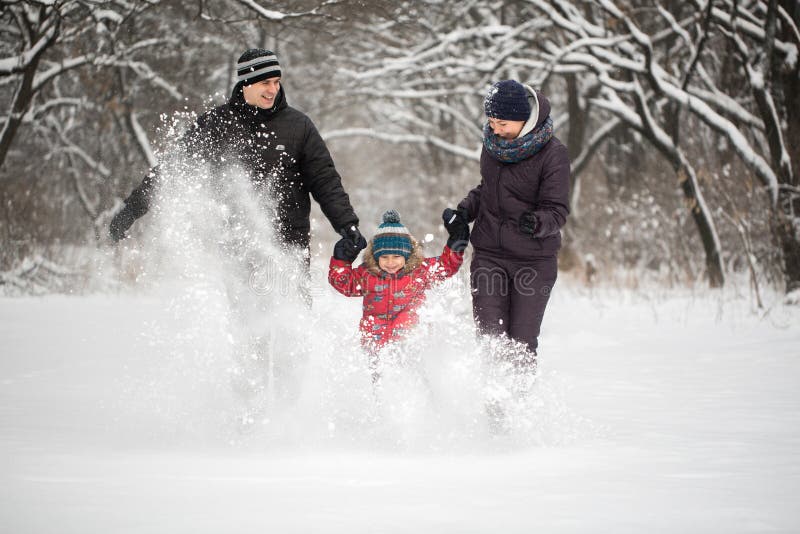 Happy Family Running on Snow in Winter. Stock Photo - Image of white ...