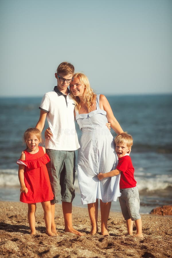 Happy family at the sea stock image. Image of ocean - 180694035