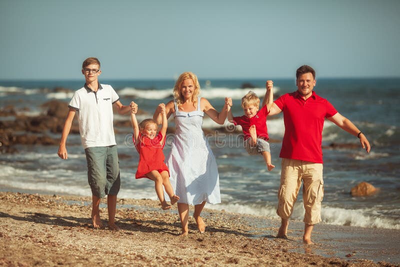 Happy family at the sea stock image. Image of ocean - 180694035