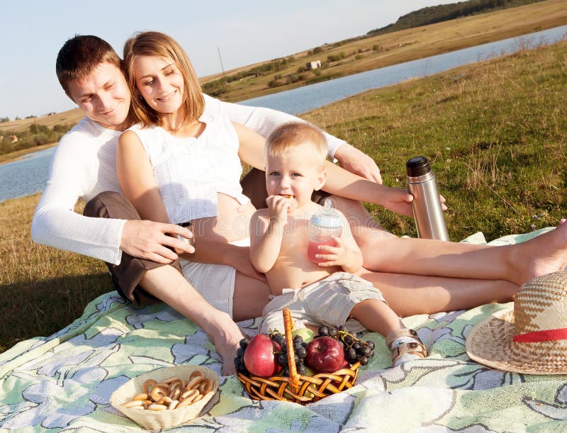 Happy Family Siting on Field Stock Image - Image of countryside, green ...