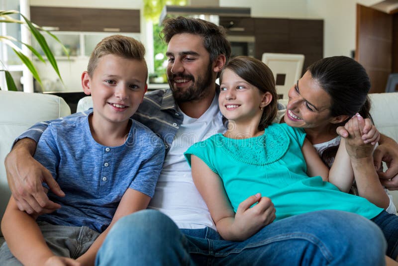 Happy Family Sitting with Arm Around on Sofa Stock Photo - Image of ...