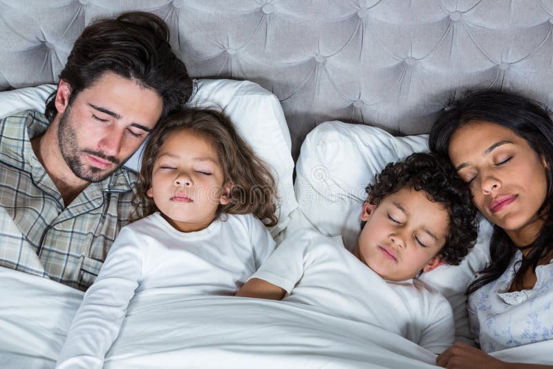Happy Family Sleeping Together Stock Photo - Image of home, leisure ...