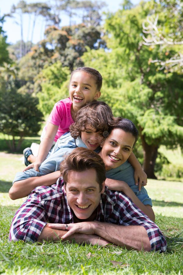 Happy Family Smiling at Camera Stock Image - Image of father, park ...