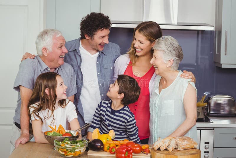 Happy Family Standing in Kitchen Stock Photo - Image of group, eating ...