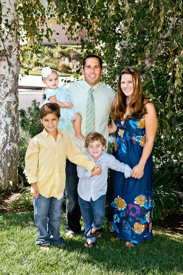 Happy Family Sitting on Grass Stock Image - Image of adult, house: 10207751