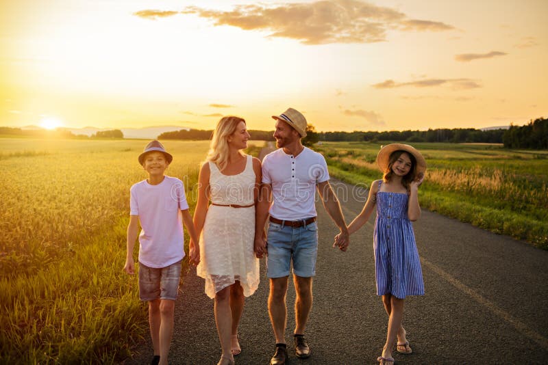 Happy Family at Sunset. they Having Fun and Playing in Nature at Sunset ...