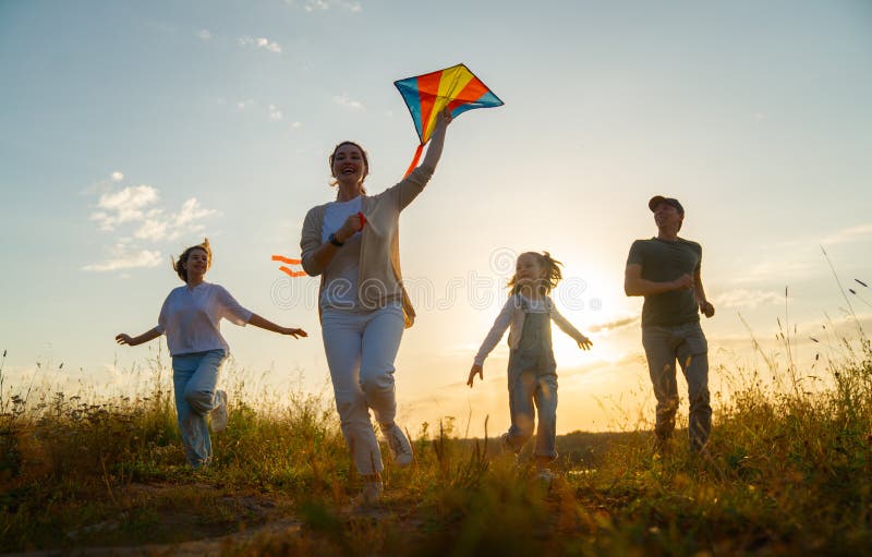 Happy family at sunset stock image. Image of active - 255258329