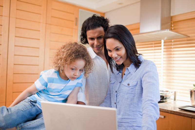 Happy Family Surfing the Internet in the Kitchen Together Stock Image ...