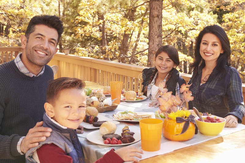 Happy Family at a Table on a Deck in a Forest Look To Camera Stock ...