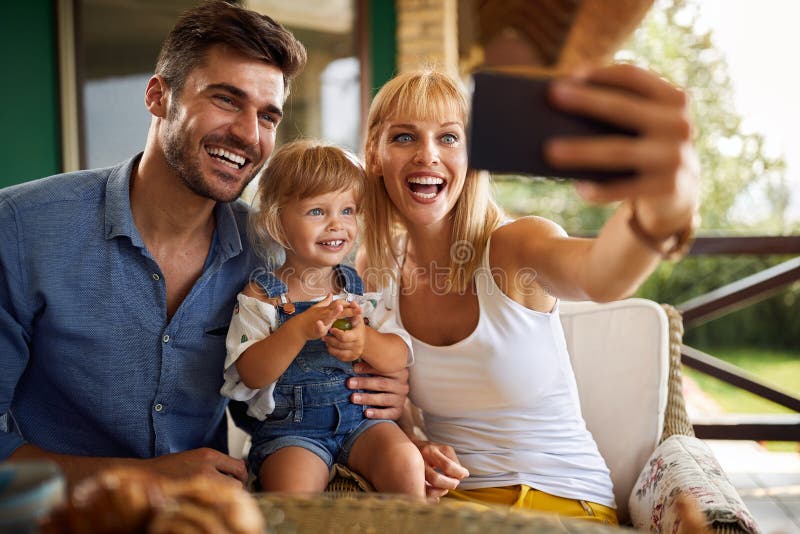 Family Taking Selfie Photo Together with Green Meadow and River View ...
