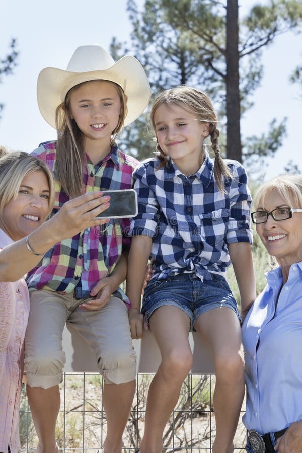 Happy Family Taking Self Portrait through Cell Phone Outdoors Stock ...
