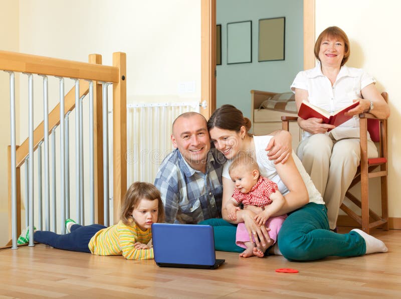 Happy Family of Three Generations Using Blue Laptop in Home Int Stock ...