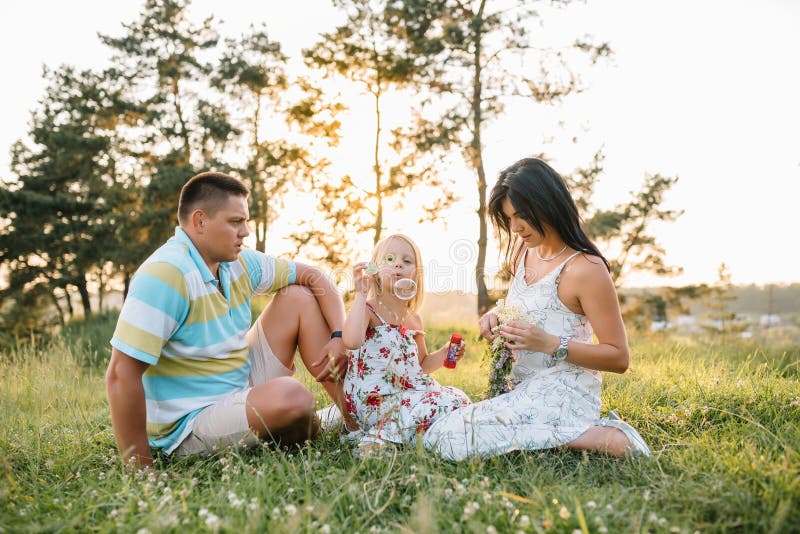 Happy Family of Three Persons Walking the Grass in the Park Stock Image ...