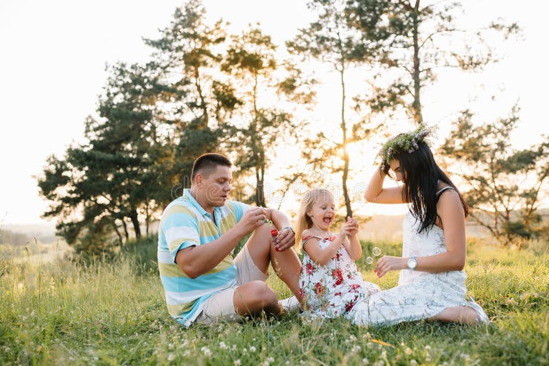 Happy Family of Three Persons Walking the Grass in the Park Stock Image ...