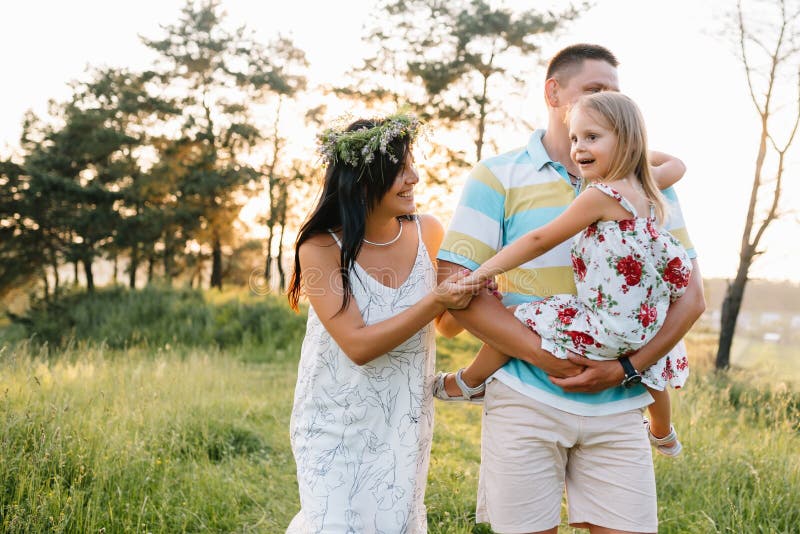 Happy Family of Three Persons Walking the Grass in the Park Stock Image ...